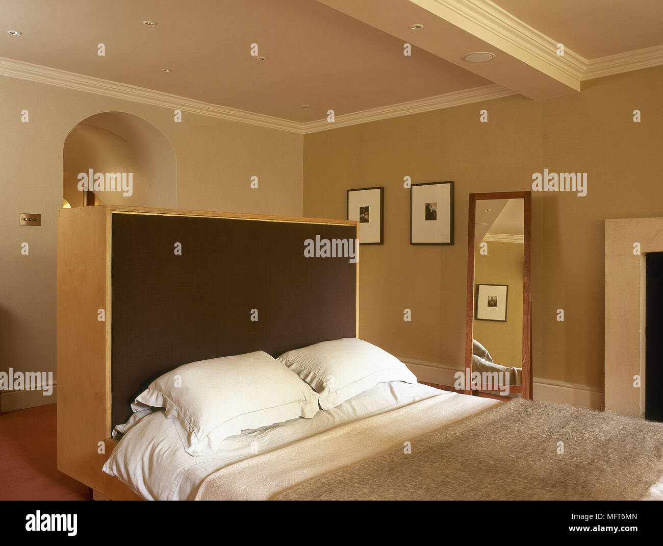 Partition headboard behind double bed Stock Photo - Alamy