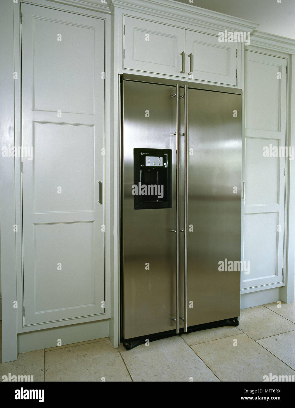 Kitchen with painted units and integrated stainless steel fridge Stock ...