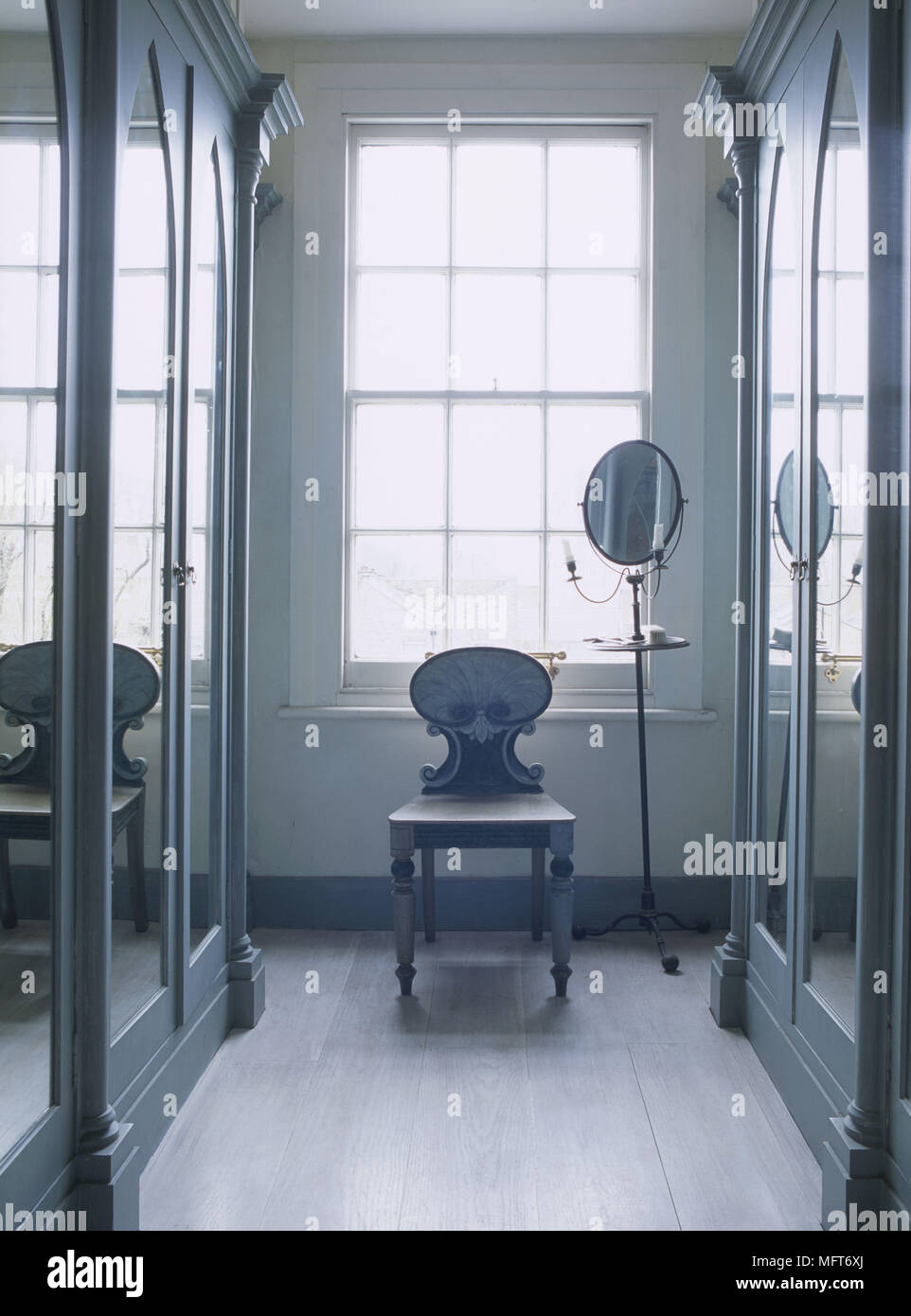 A traditional dressing room with painted gothic style mirrored ...