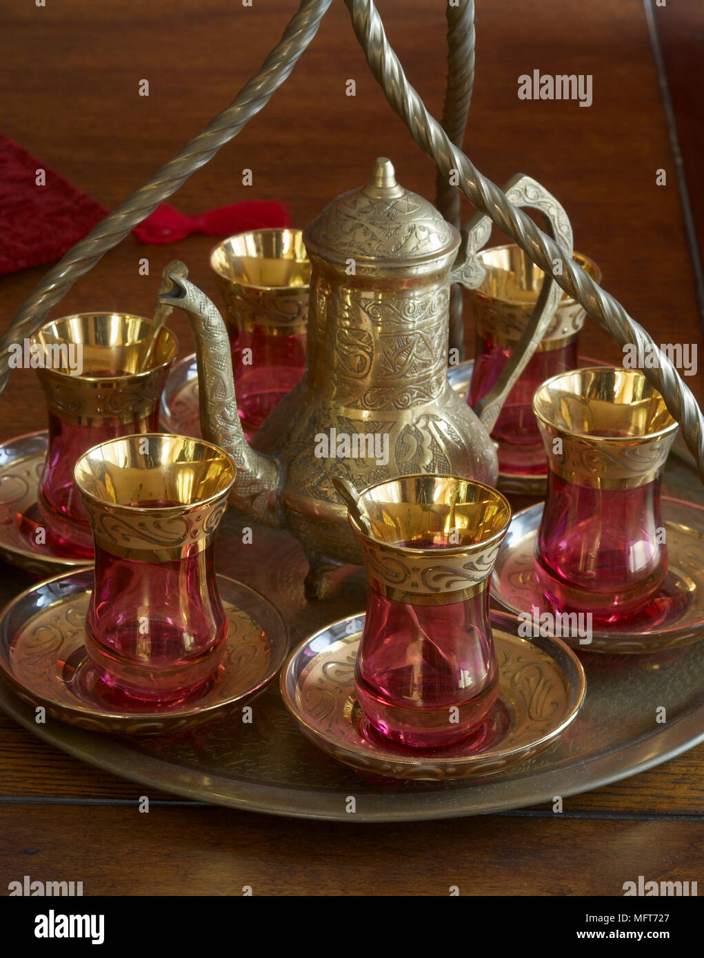 Turkish style red glass cups with brass tops and teapot on brass tray ...