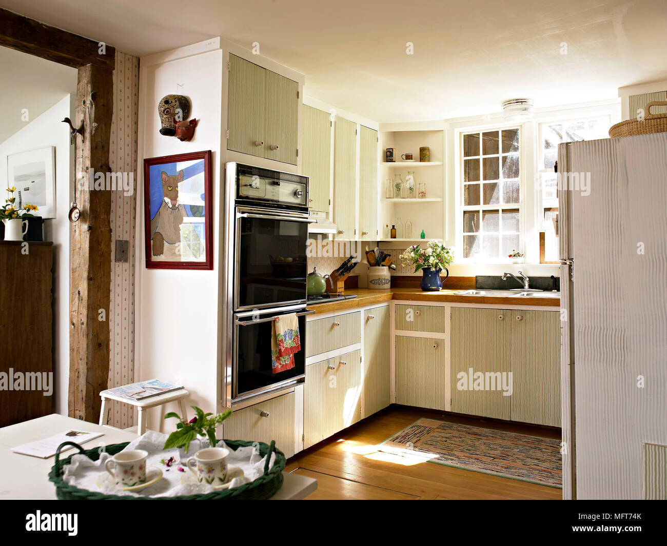 Kitchen with wood units and integral oven Stock Photo - Alamy