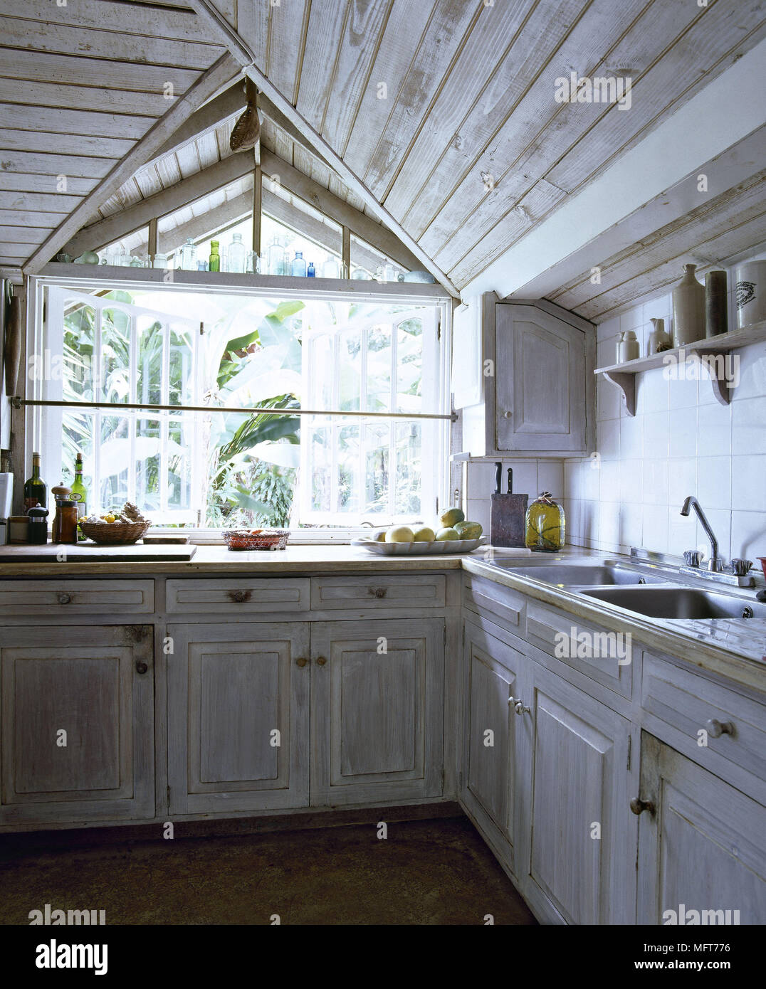 A country kitchen with pitched timber roof wood units Stock Photo - Alamy