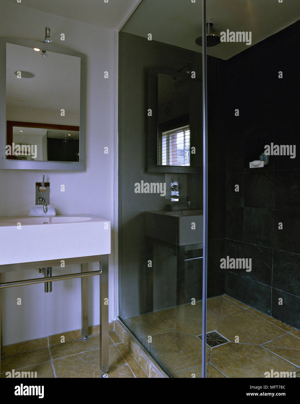 A detail of a modern bathroom washbasin shower cubicle stone floor ...