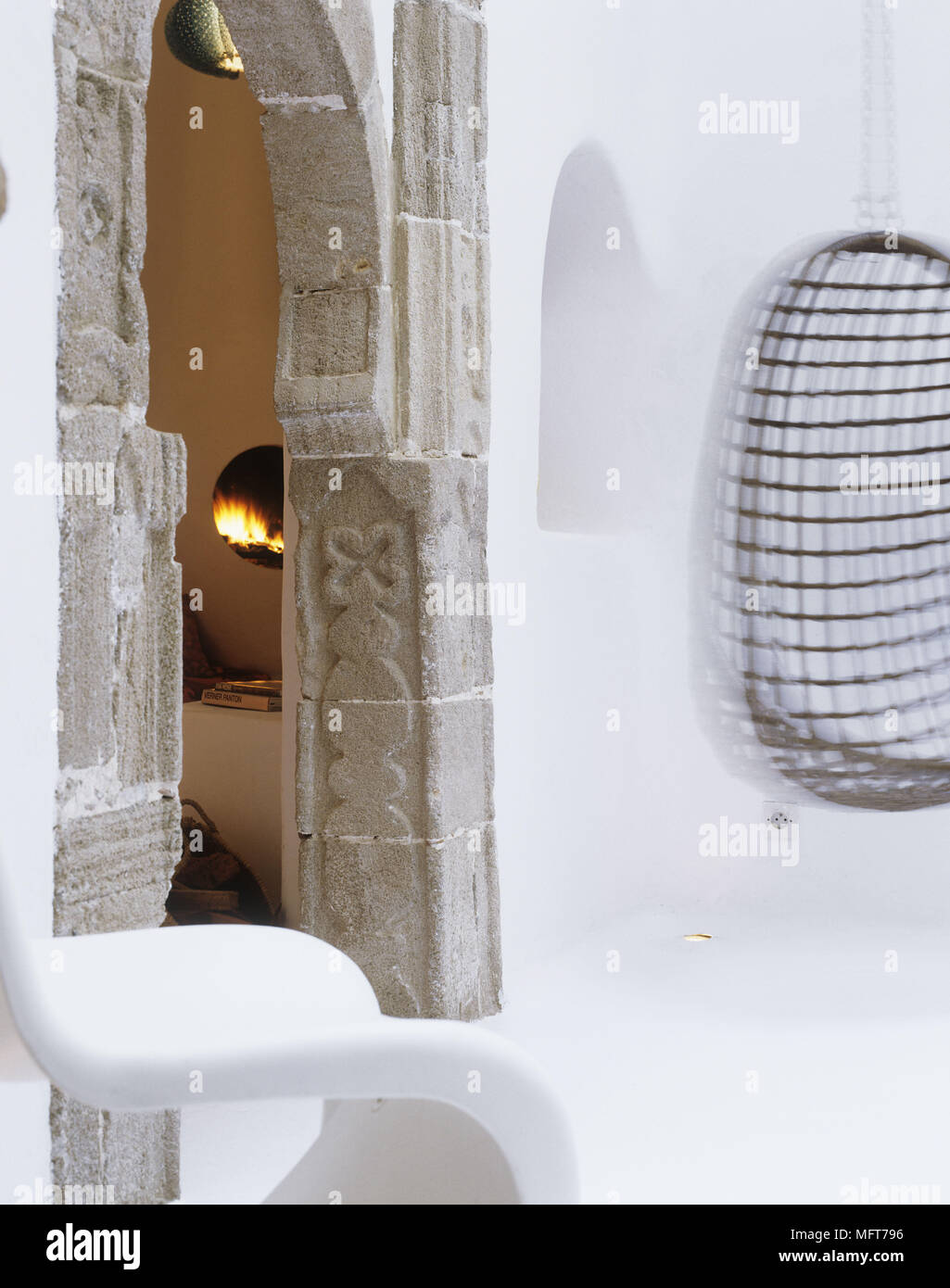 A detail of a rustic whitewashed sitting room stone Moroccan archway ...
