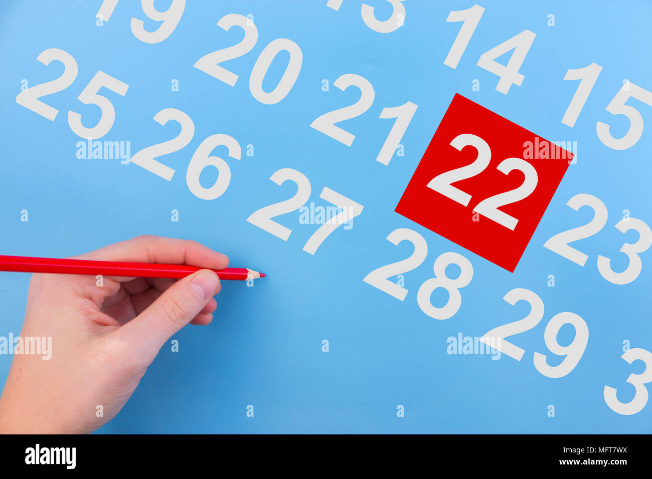 A female hand circling the date with red pen Stock Photo - Alamy