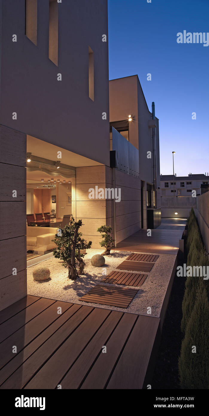 Exterior of new build house lit at night Stock Photo - Alamy