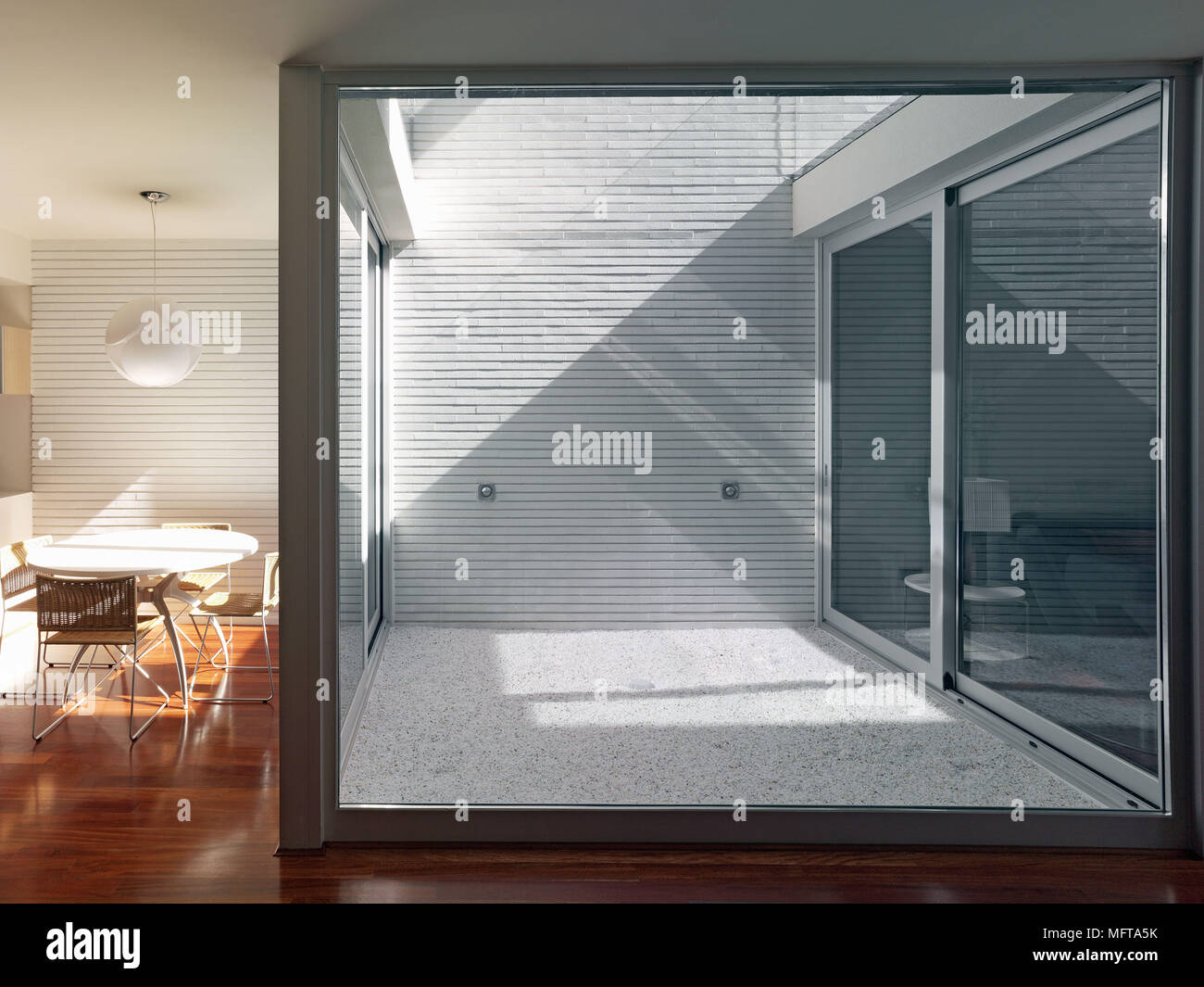 Interior architectural feature with glass panels and sliding doors ...