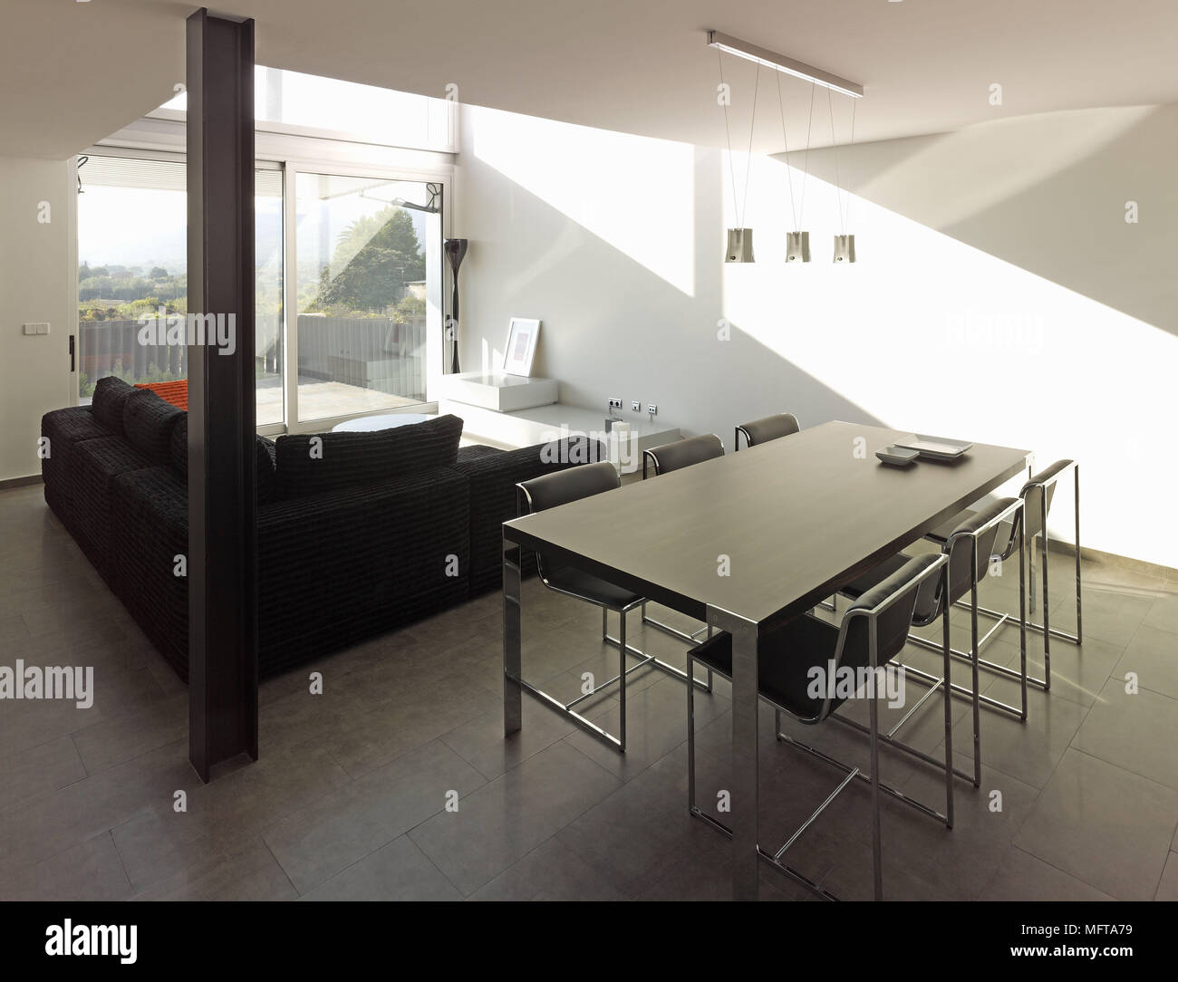 Modern open plan room with seating and dining areas Stock Photo - Alamy