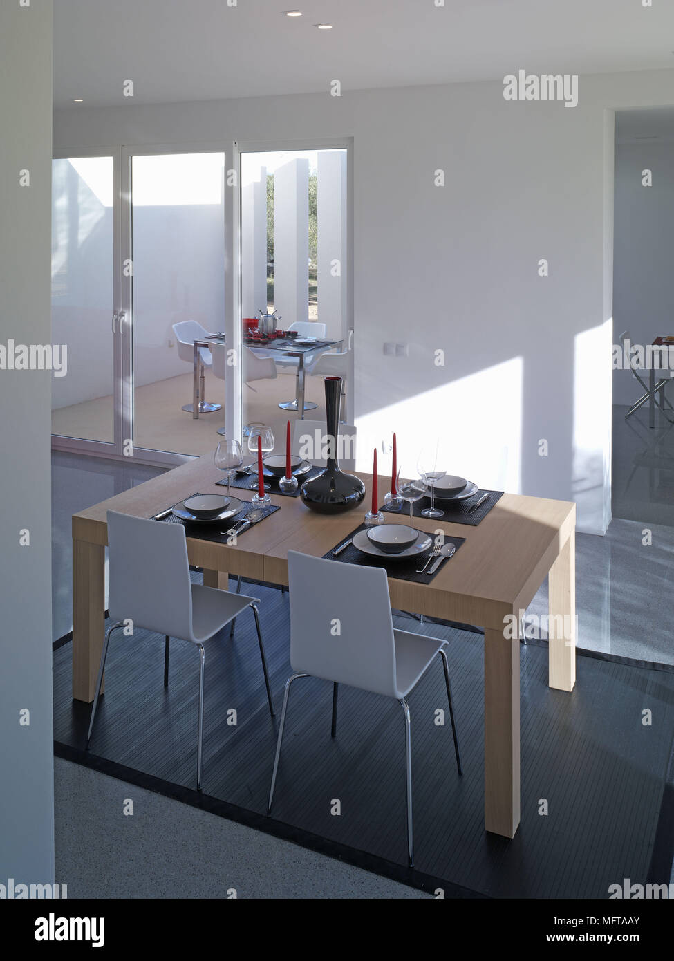 Table set for dinner in modern dining room Stock Photo - Alamy