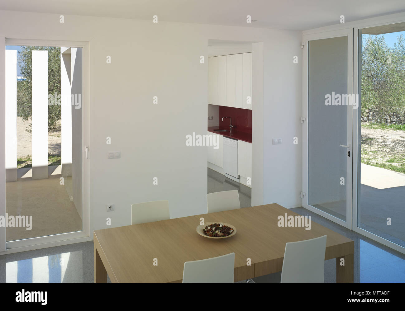 Wooden table and chairs in modern minimalist dining room Stock Photo ...