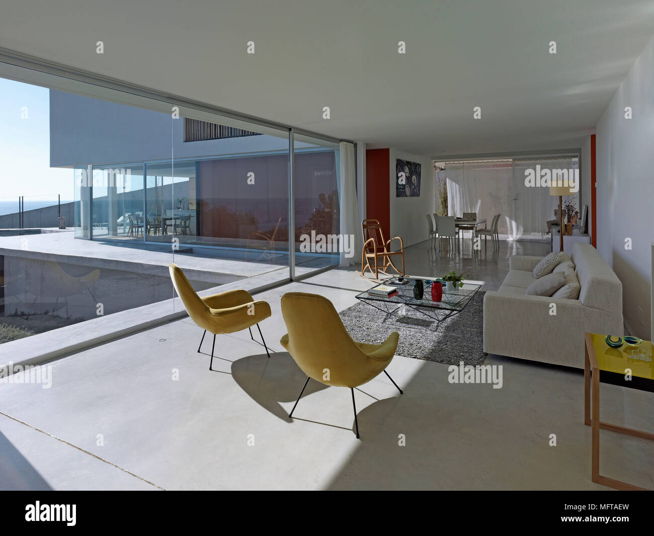 Upholstered sofa in contemporary sitting room facing floor to ceiling ...