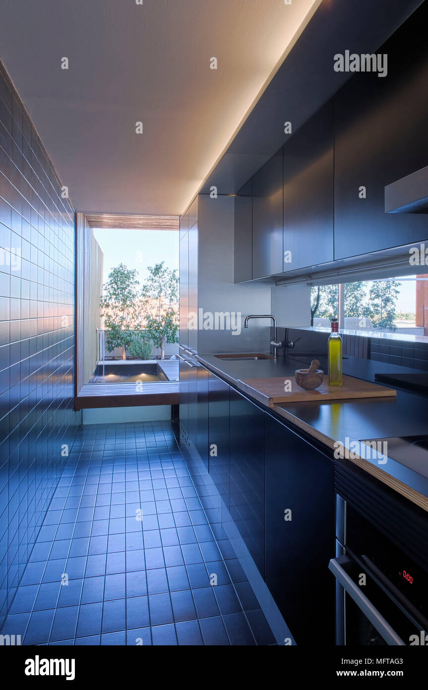 Modern narrow kitchen with blue tiled wall and floor Stock Photo - Alamy
