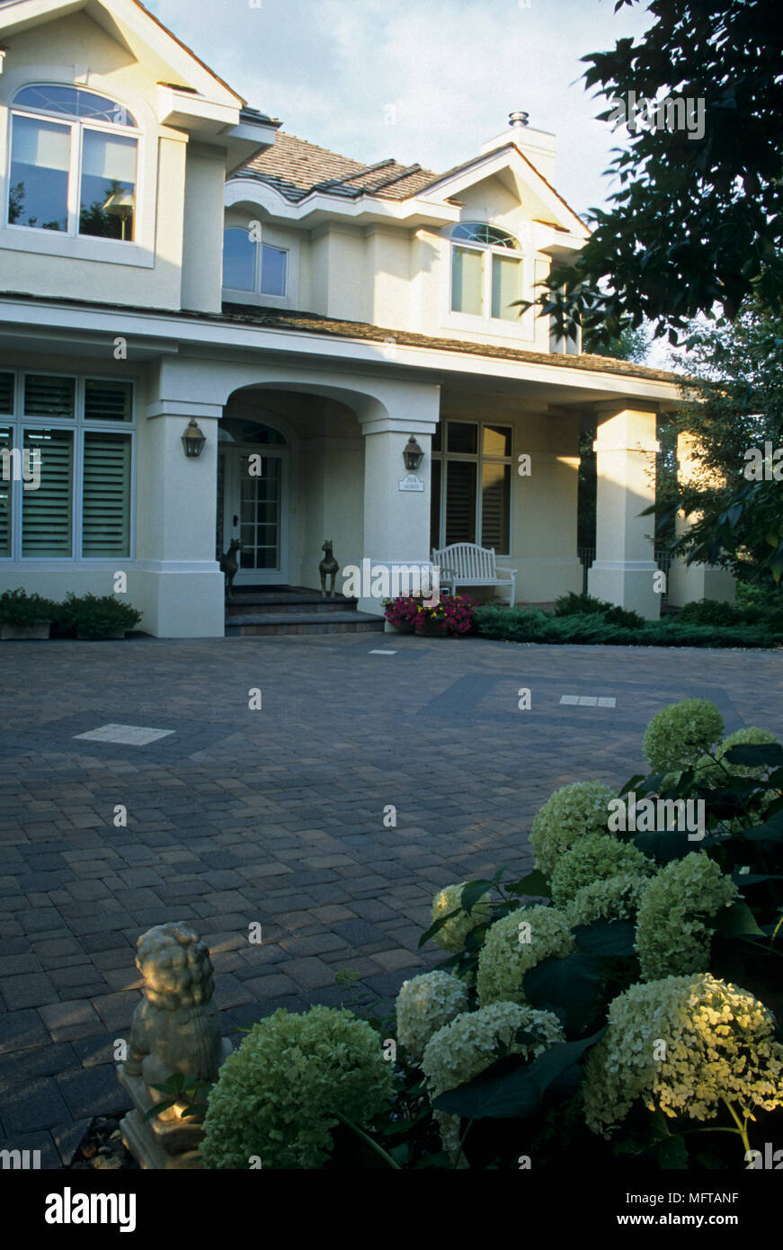 Large patio drive in front of two storey house Stock Photo - Alamy
