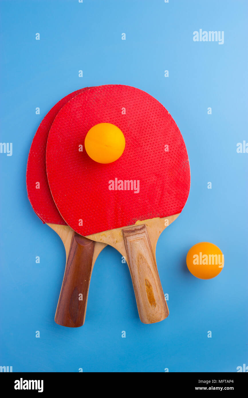 Table tennis rackets and balls on blue background Stock Photo - Alamy