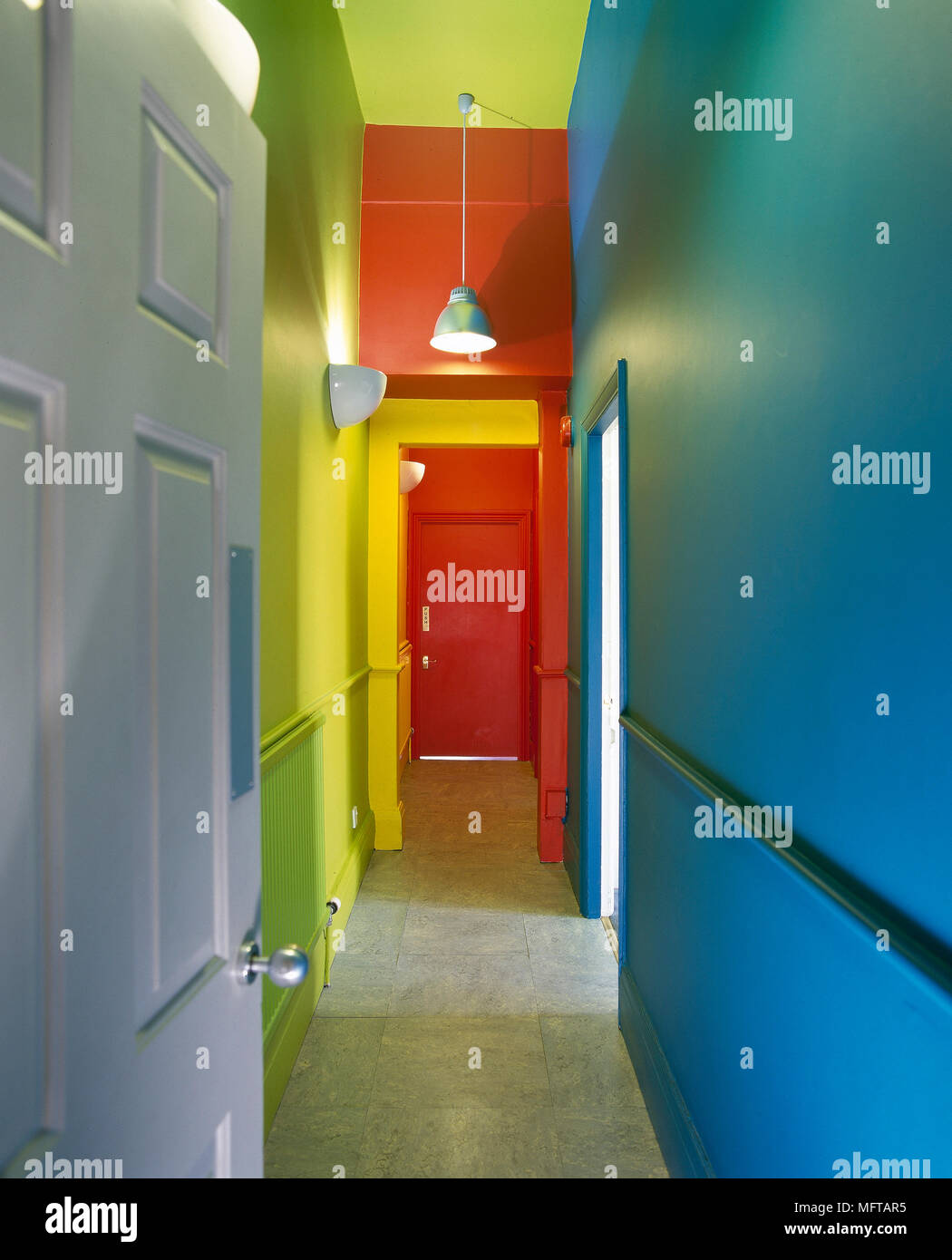 View through open door to hallway with brightly coloured walls Stock ...