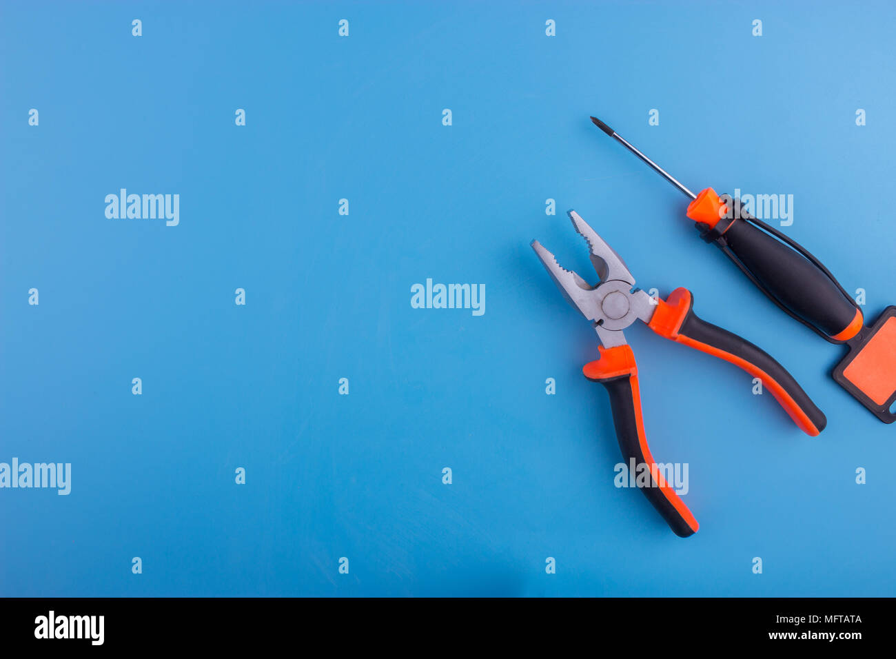 Tin snips gripping tongs nippers on scratched vintage metallic background construction concept Stock Photo Alamy