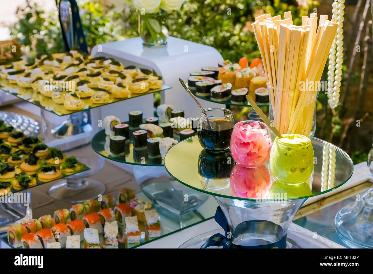 A table of fresh sushi and canapés for catering at a gala event or ...