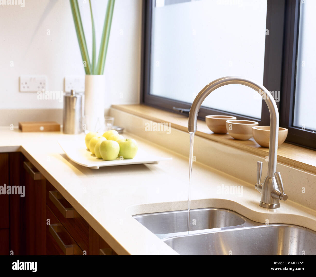 Modern kitchen detail with a platter of fruit, sunny window, and a ...