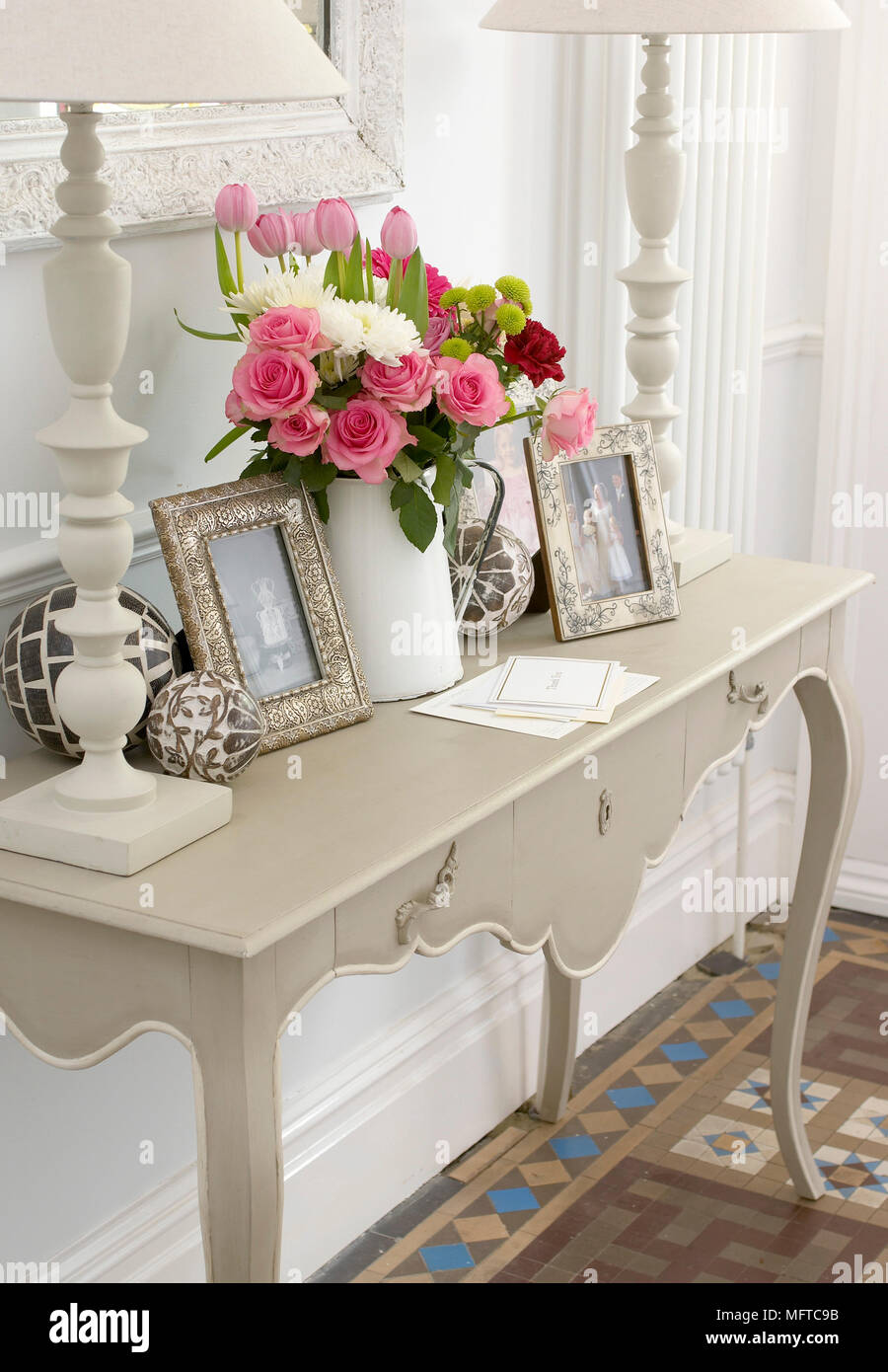 Two lamps on period style table in hallway Stock Photo - Alamy