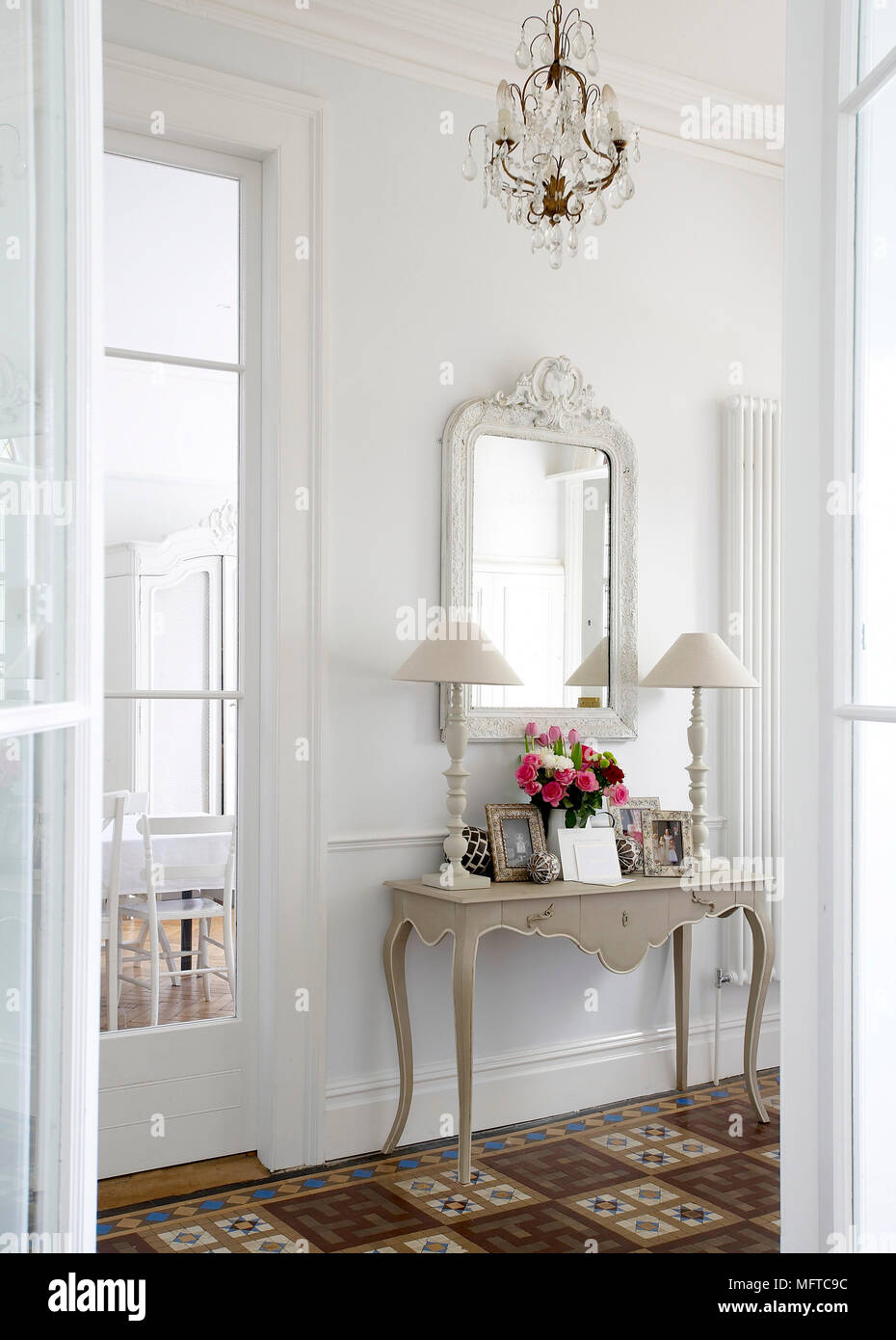 Two lamps on period style table in hallway Stock Photo - Alamy