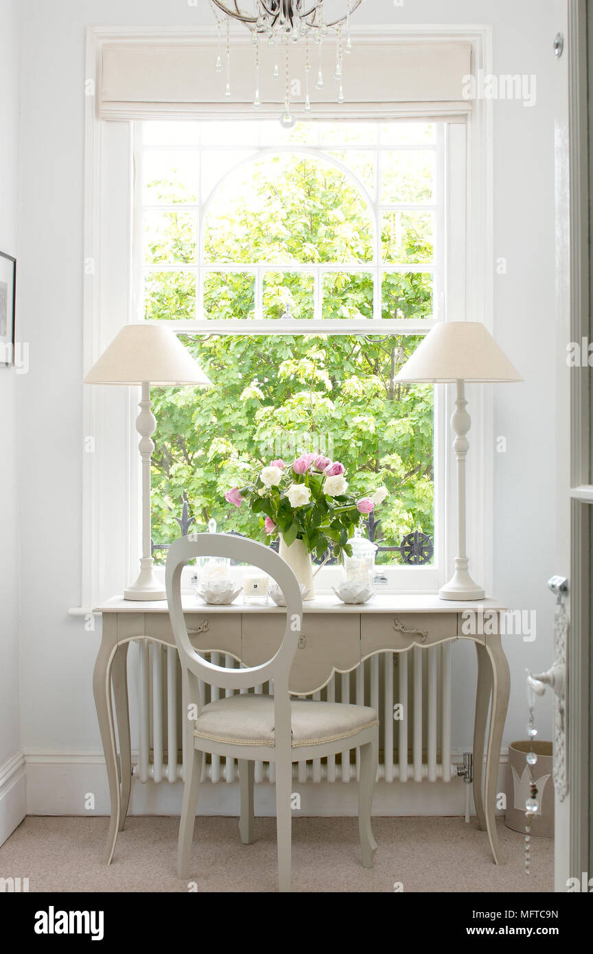 Two lamps on period table below window Stock Photo - Alamy