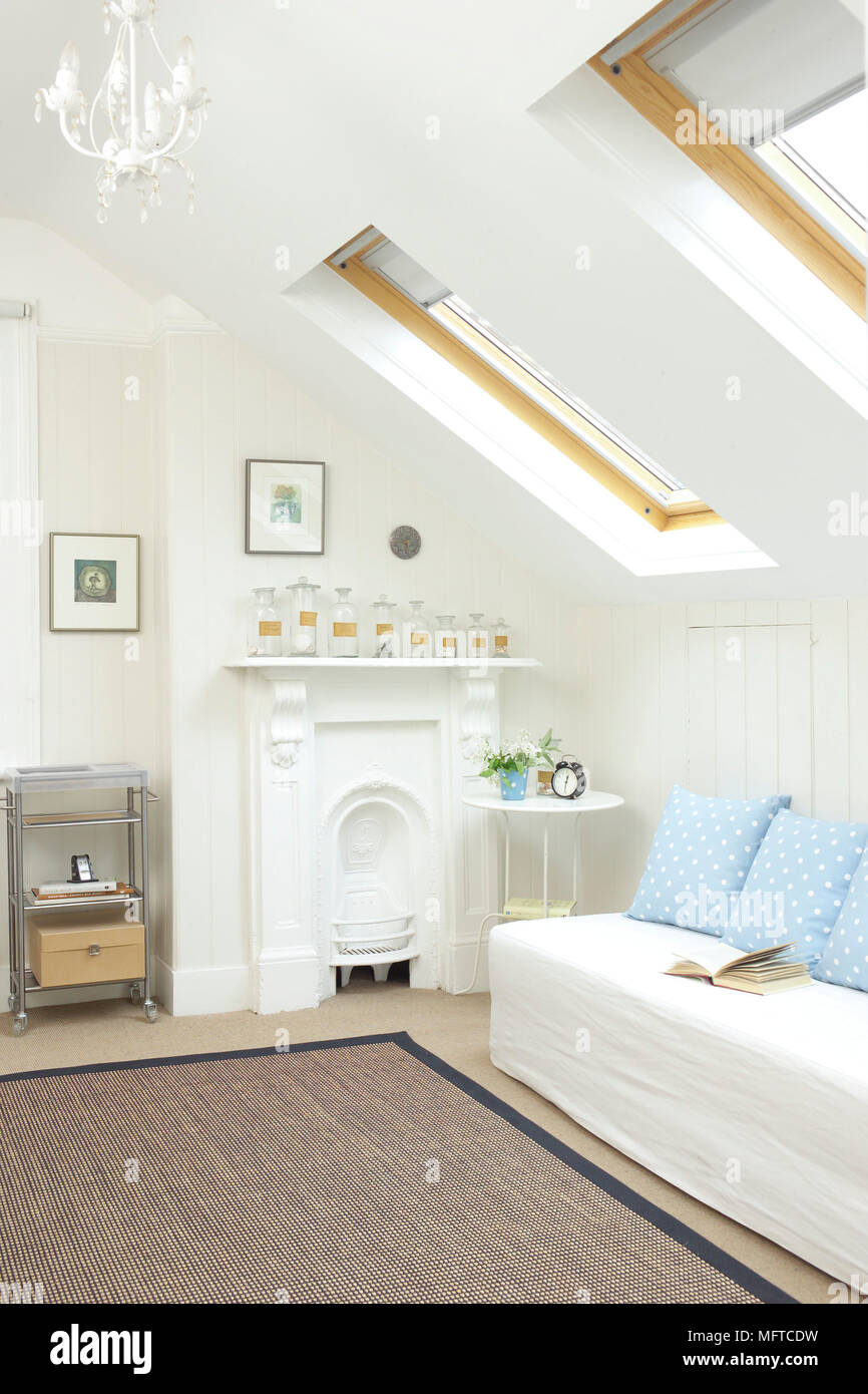 Fireplace in attic room with skylight windows Stock Photo - Alamy