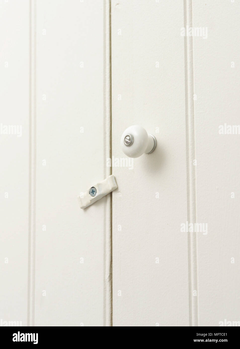 White cupboard with handle and latch Stock Photo - Alamy