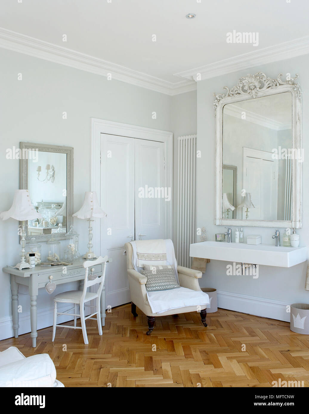 Chair next to two washbasins in spacious bathroom Stock Photo - Alamy