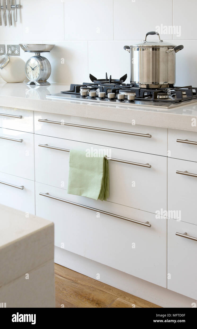 Modern kitchen with white fitted units with hob Stock Photo - Alamy