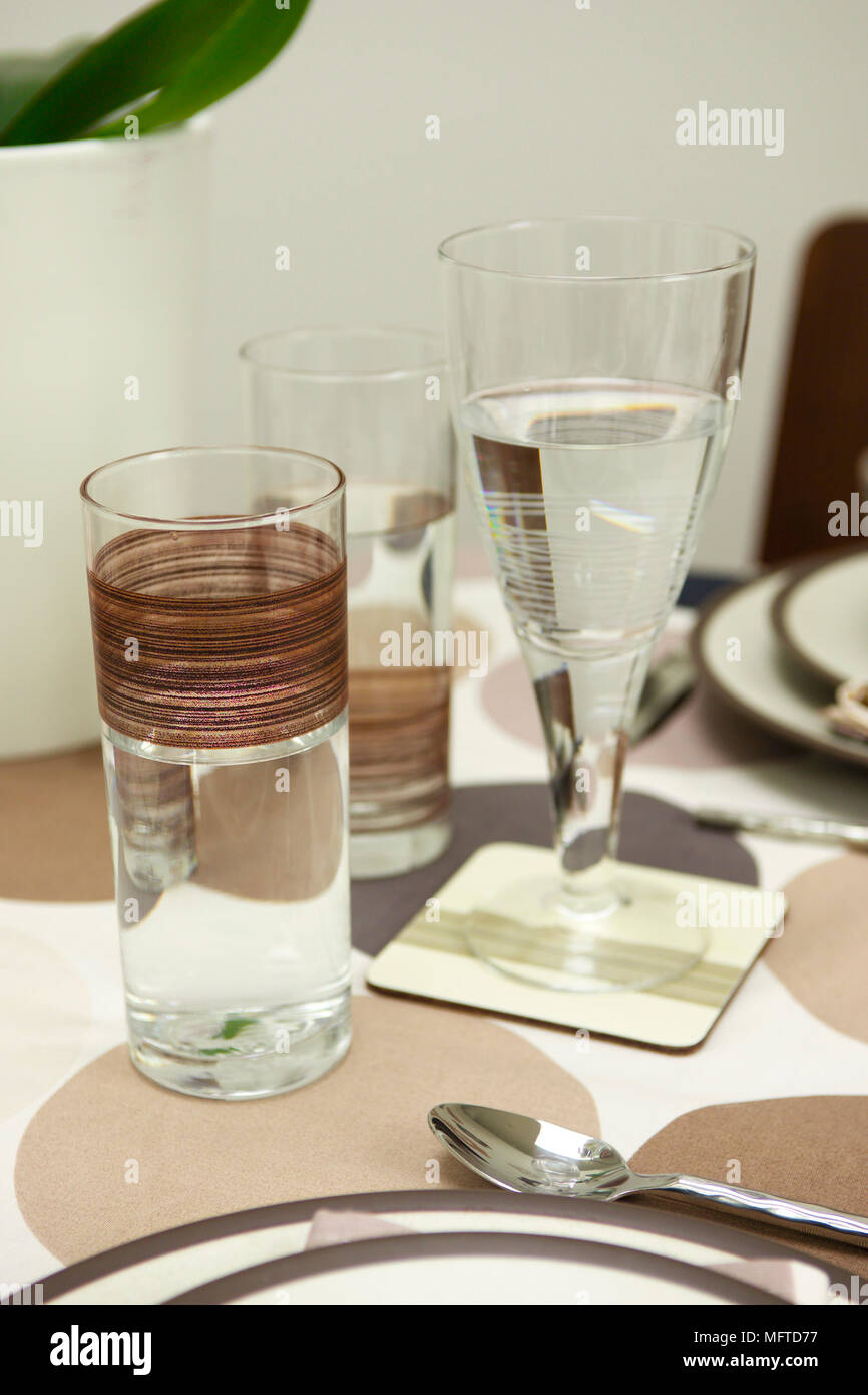 Drinking glasses on dining table Stock Photo - Alamy