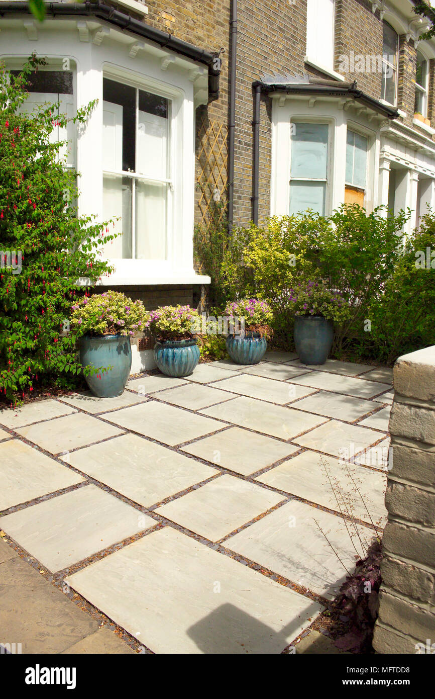 Exterior of paved front garden of terraced town house Stock Photo - Alamy