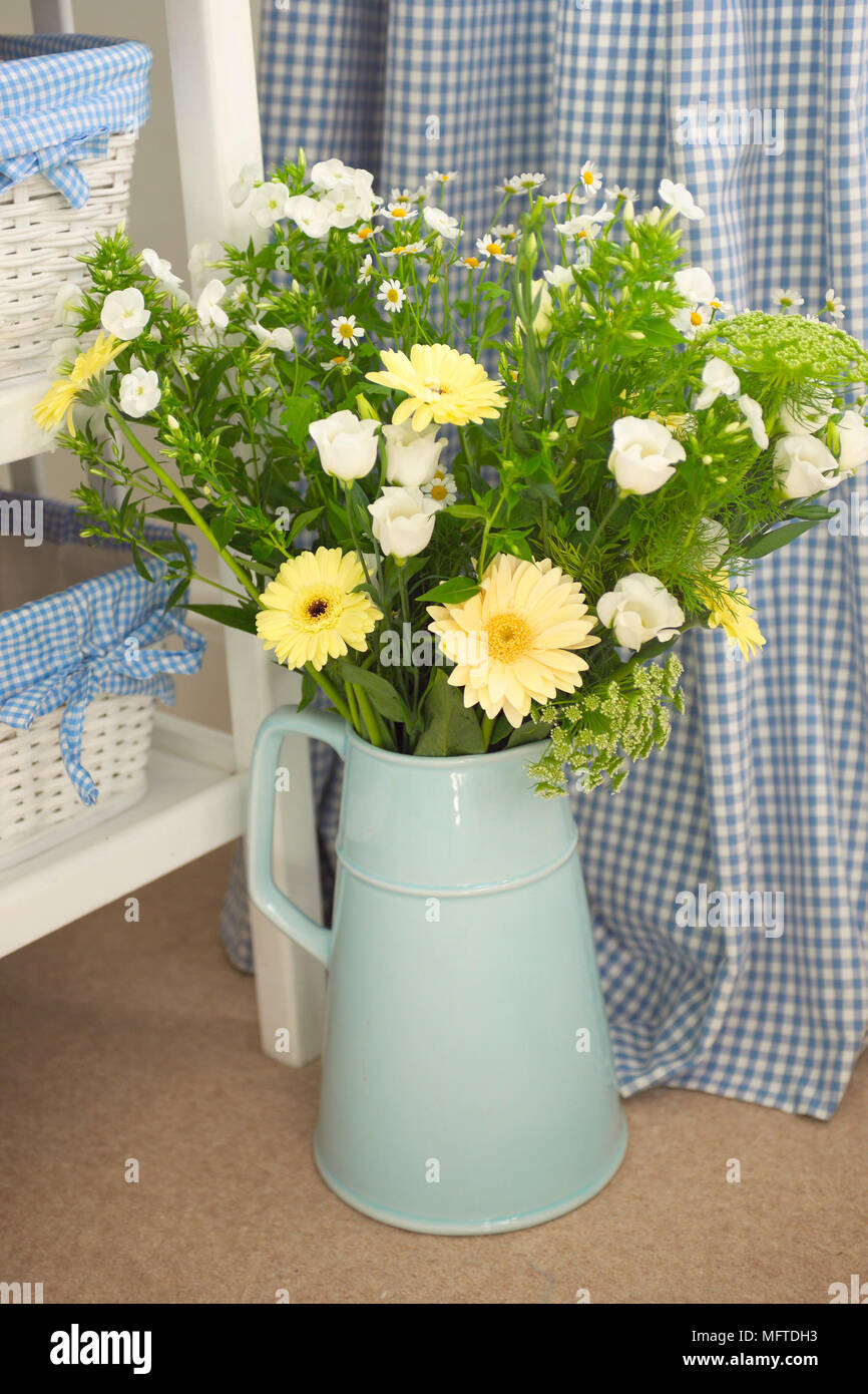 Flower arrangement in blue jug Stock Photo - Alamy