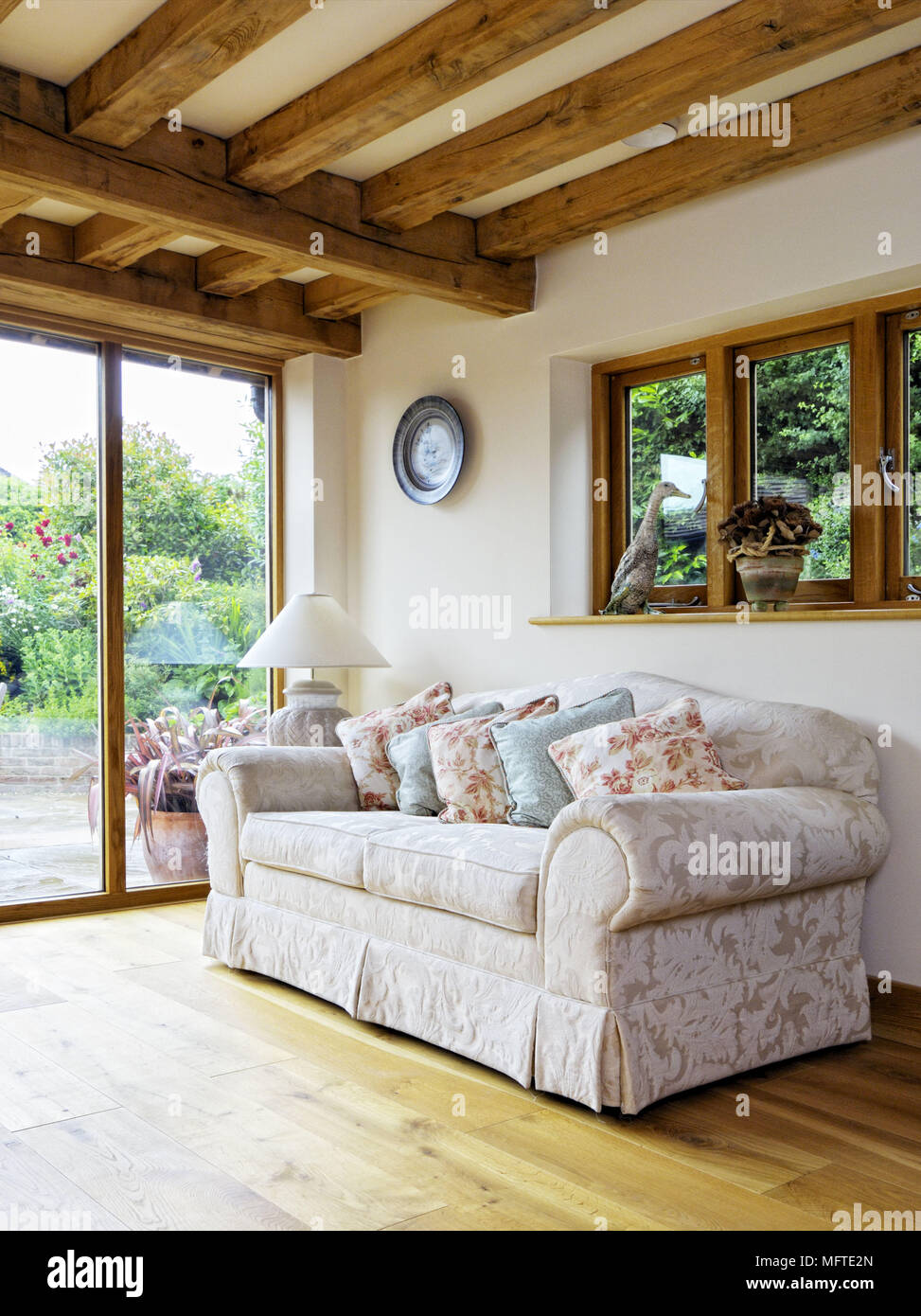Upholstered sofa in country style sitting room Stock Photo - Alamy