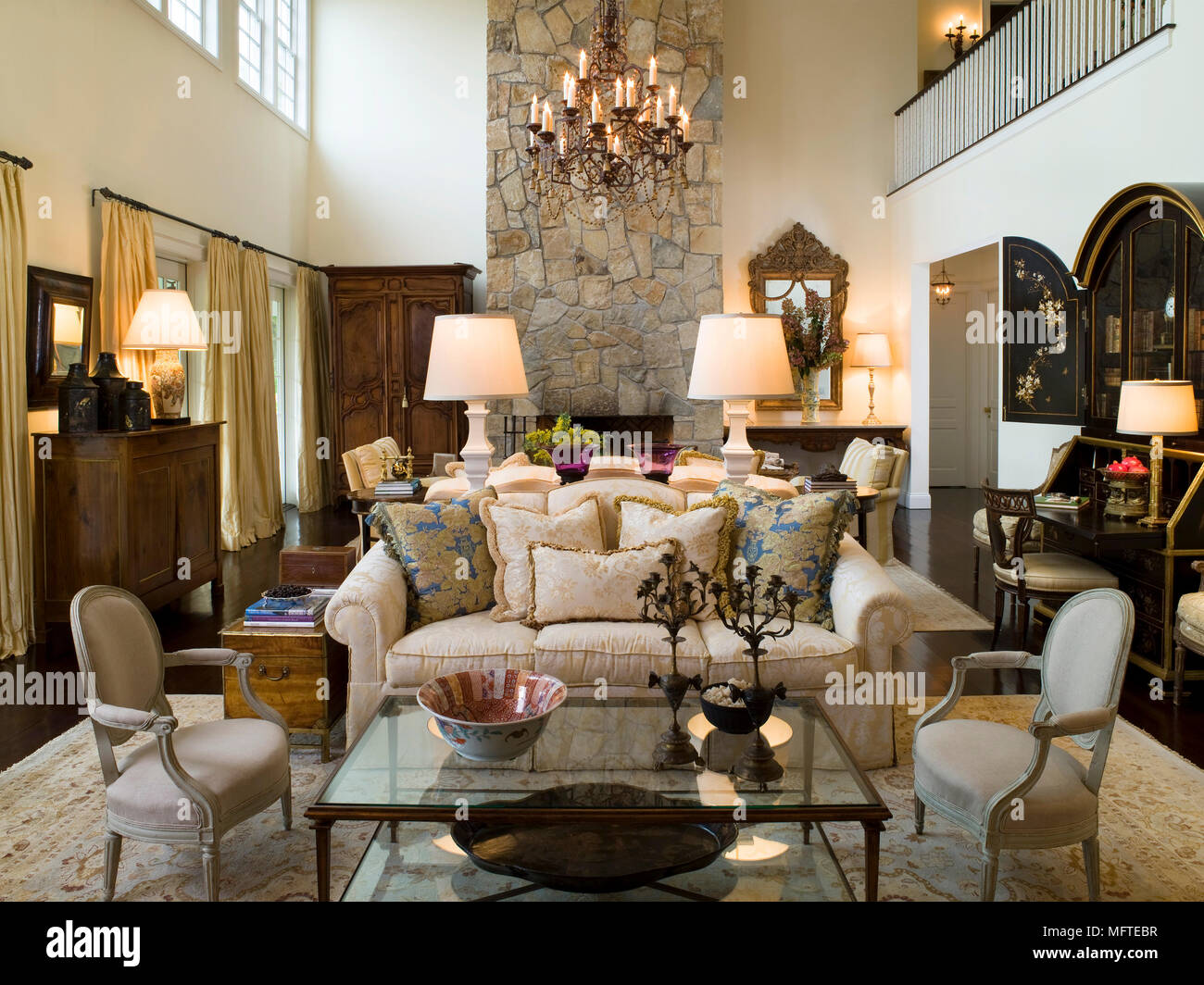 Upholstered seating around coffee table in opulent sitting room Stock ...
