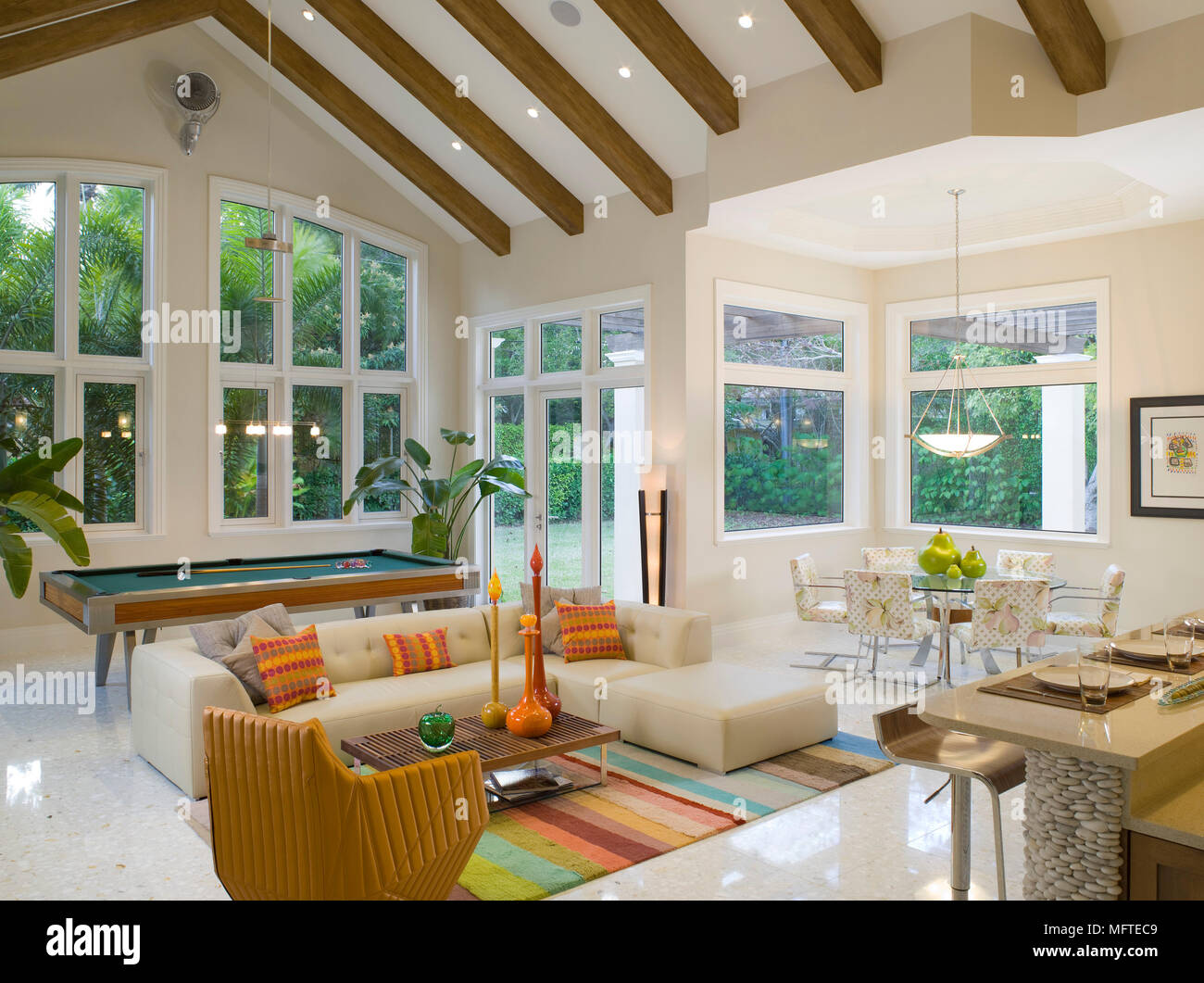 Upholstered seating in modern open plan sitting room with dining area ...