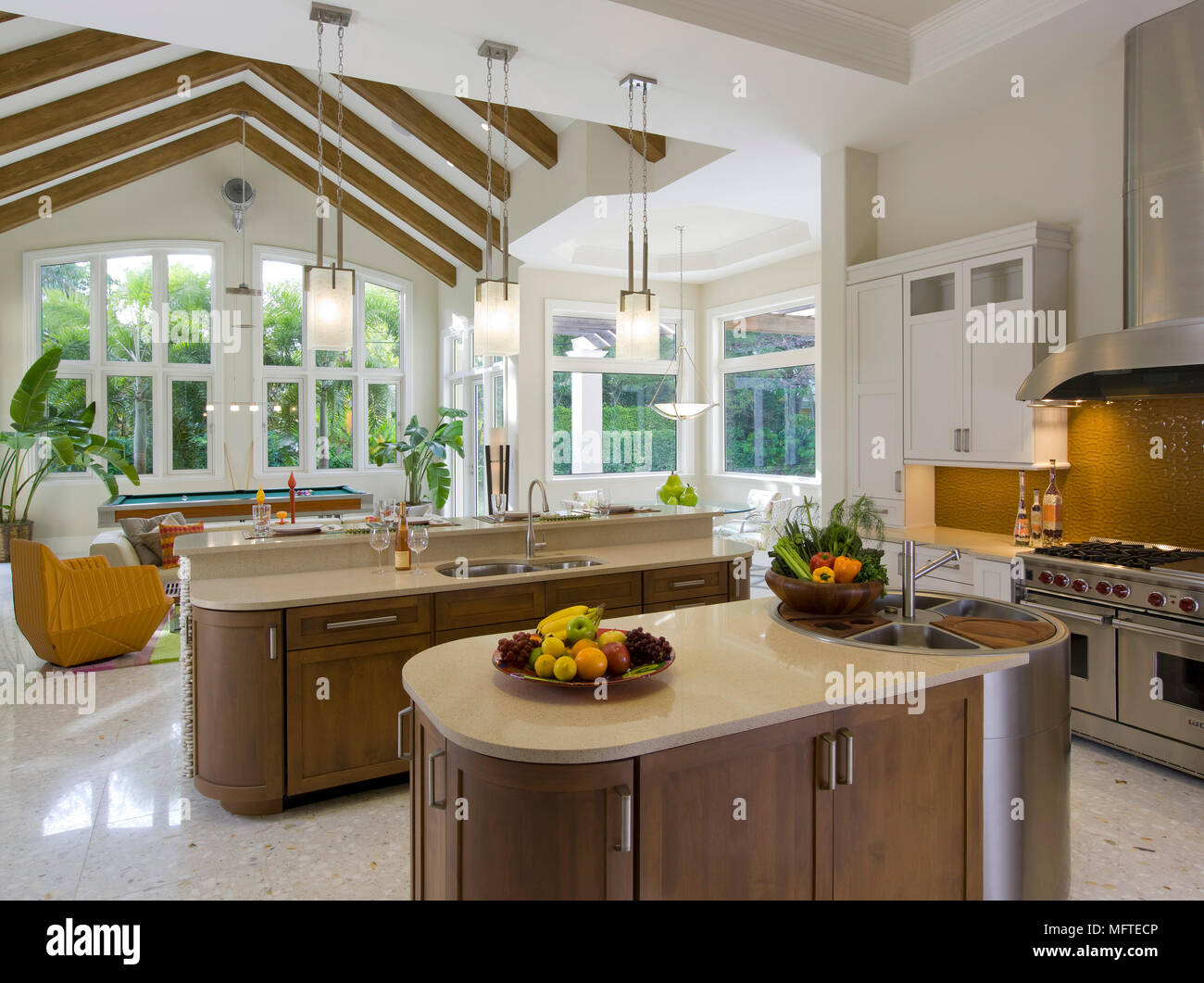 Central island units in modern spacious kitchen Stock Photo - Alamy