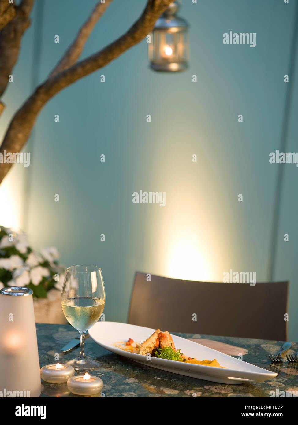 Food on plate on dining table Stock Photo - Alamy
