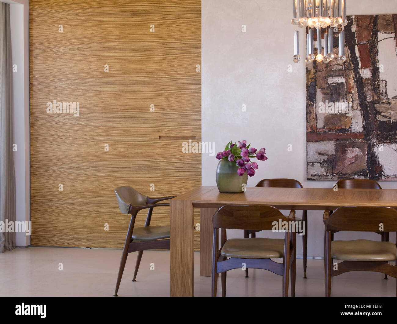 Pendant light above wooden table in modern dining room Stock Photo - Alamy