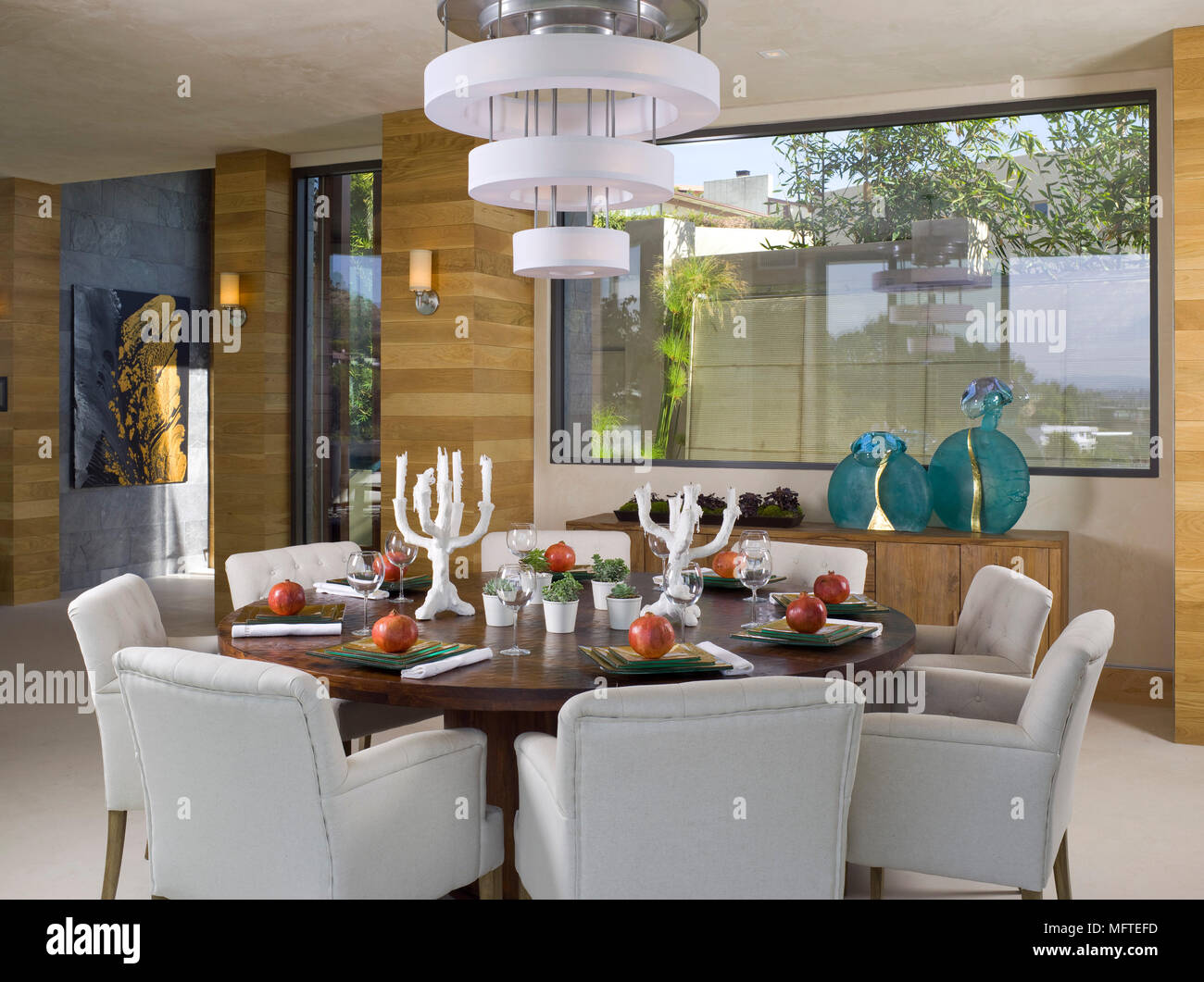 Upholstered chairs around table in modern dining room Stock Photo - Alamy