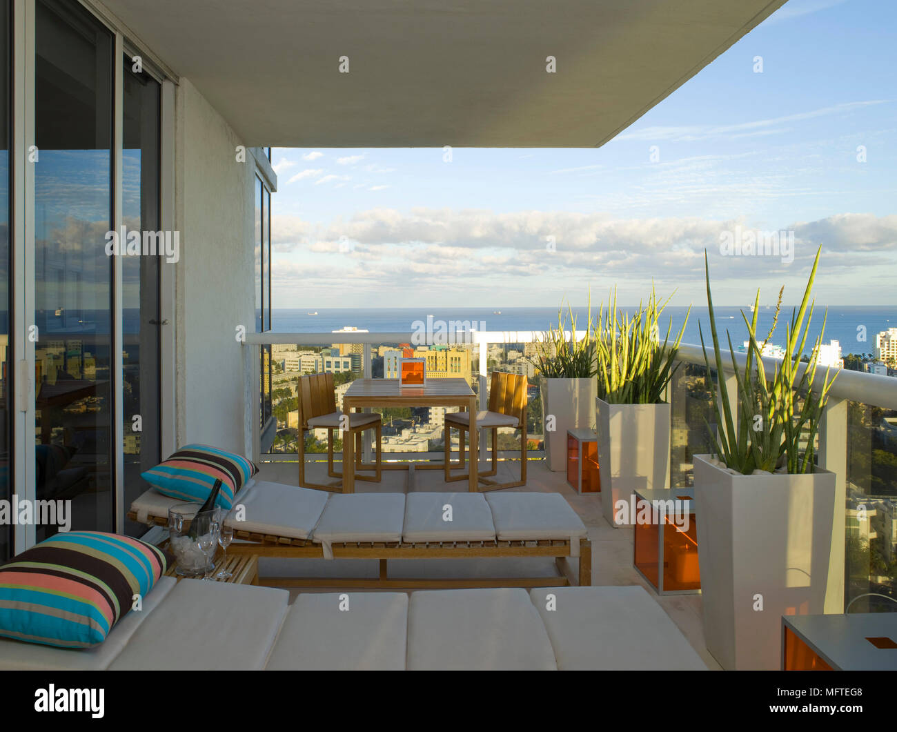 Two sunloungers on balcony with modern pot planters Stock Photo - Alamy