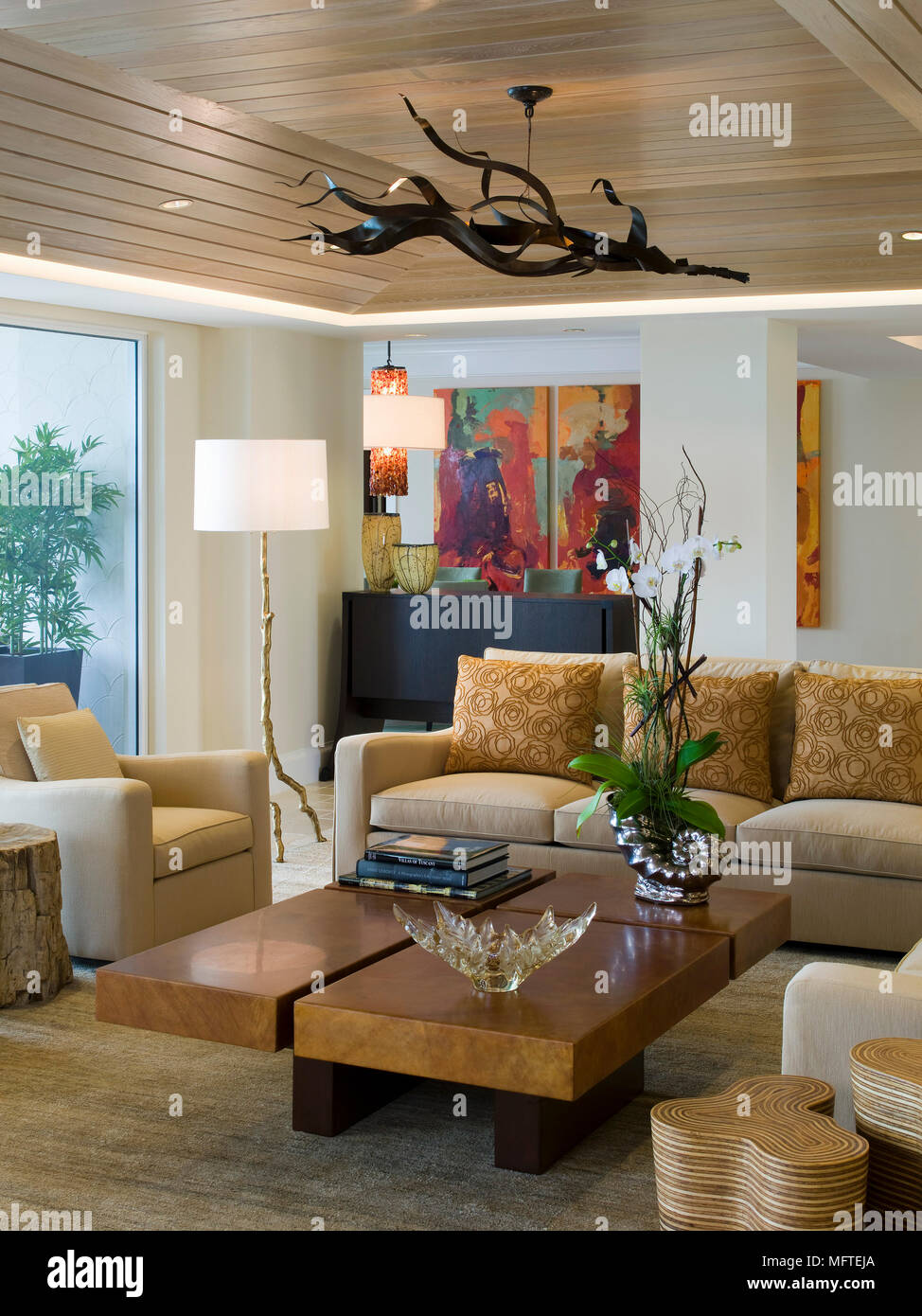 Upholstered seating arranged around coffee table in modern sitting room ...
