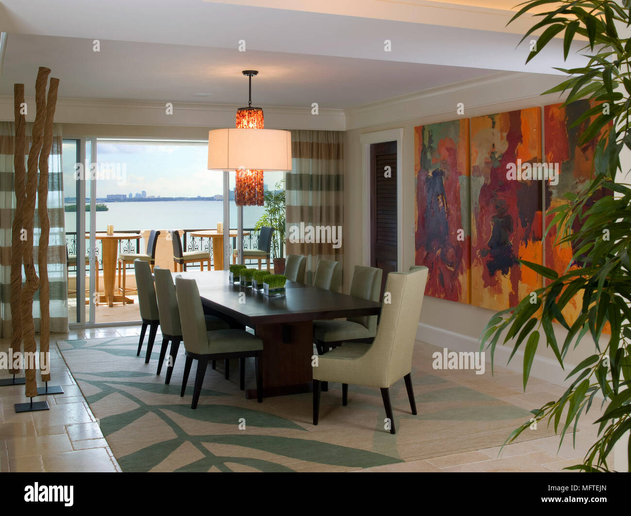 Upholstered chairs around table in modern dining room Stock Photo - Alamy