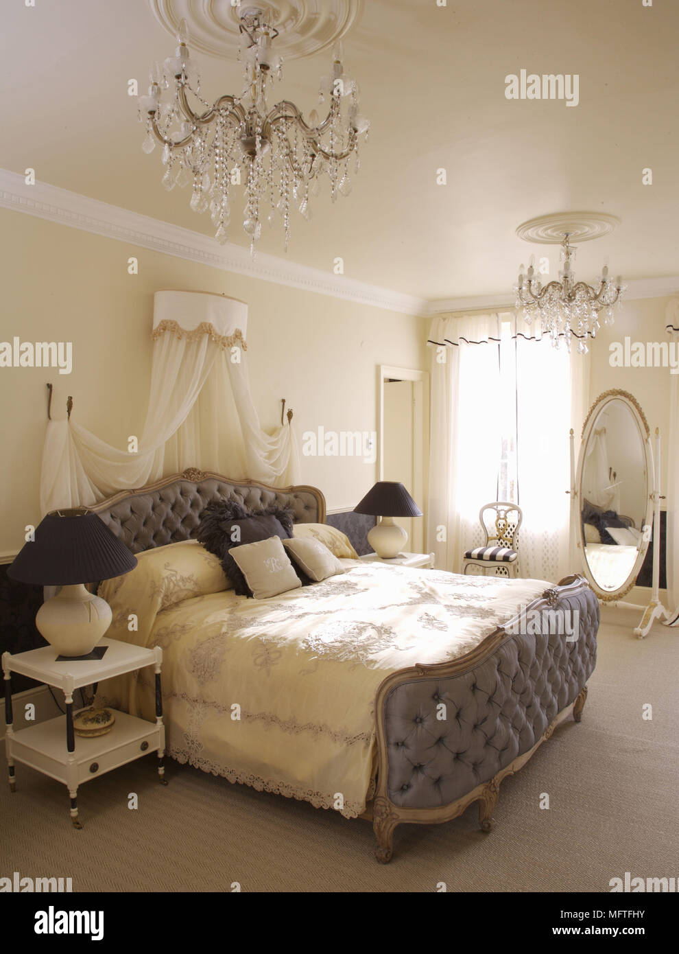 Opulent bedroom with upholstered double bed with fabric canopy Stock ...