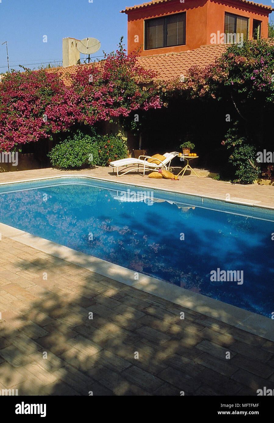 Red painted villa with outdoor swimming pool Stock Photo - Alamy