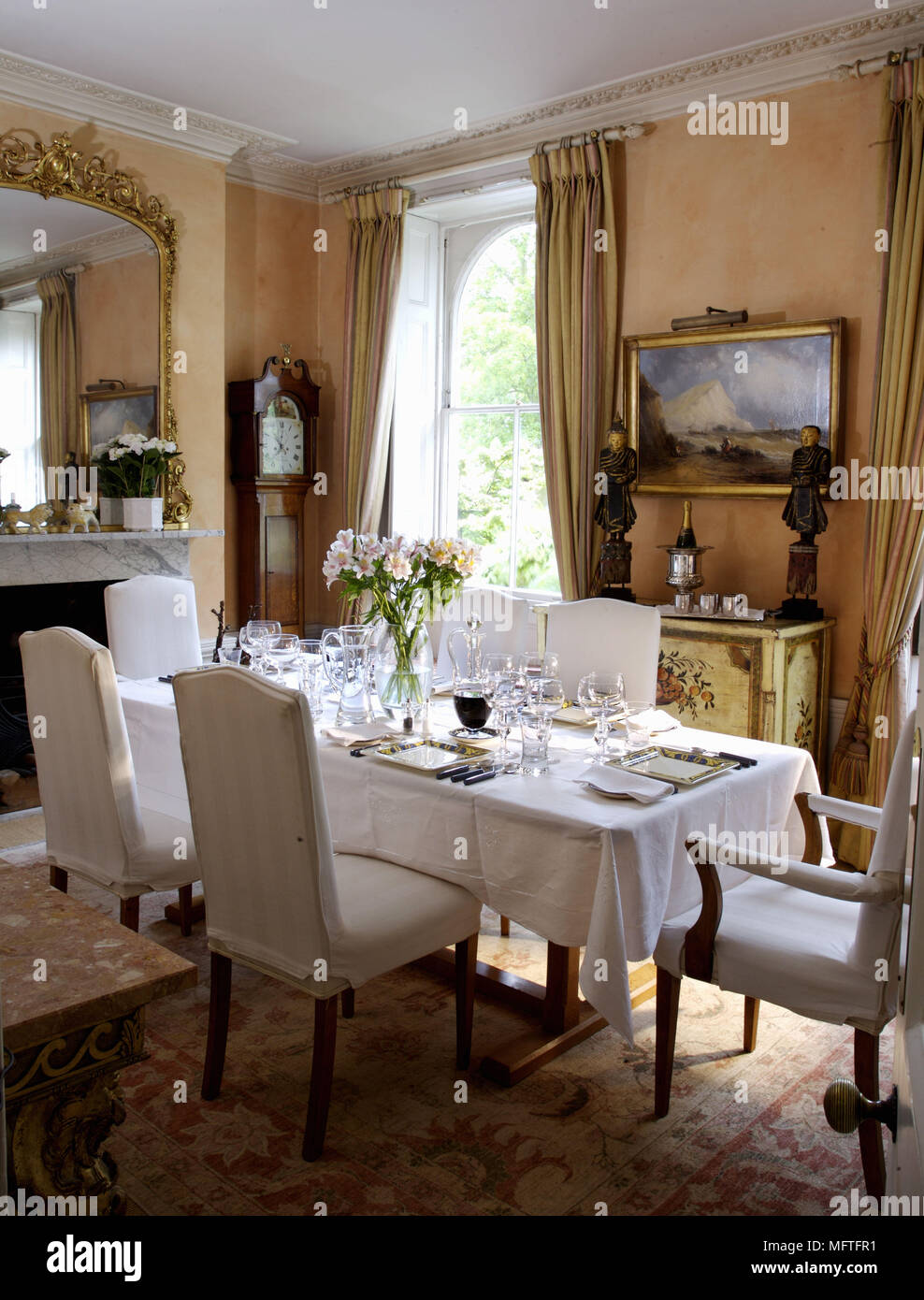 Table set for dinner in traditional style dining room Stock Photo - Alamy