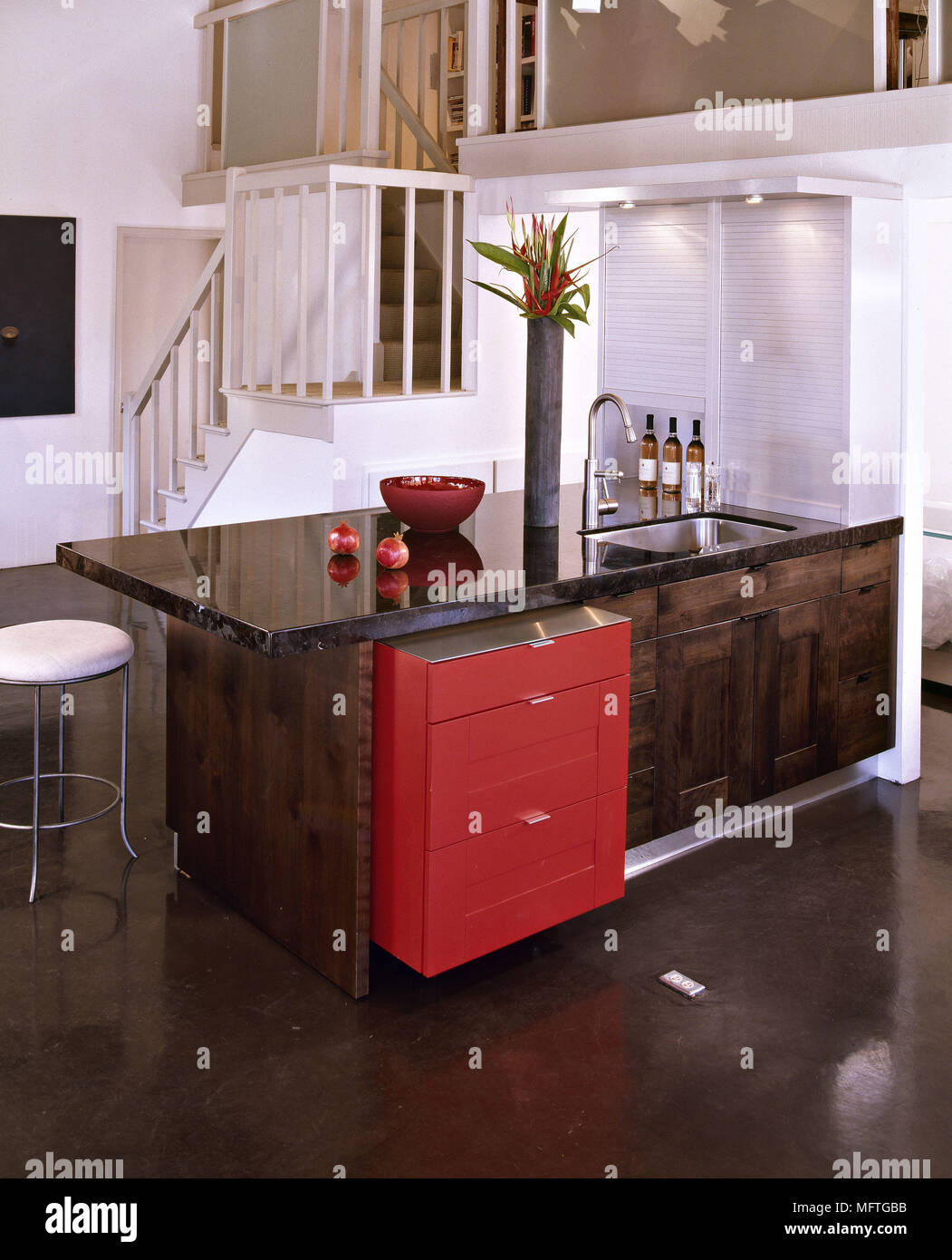 Modern open plan kitchen with central island unit and black granite ...