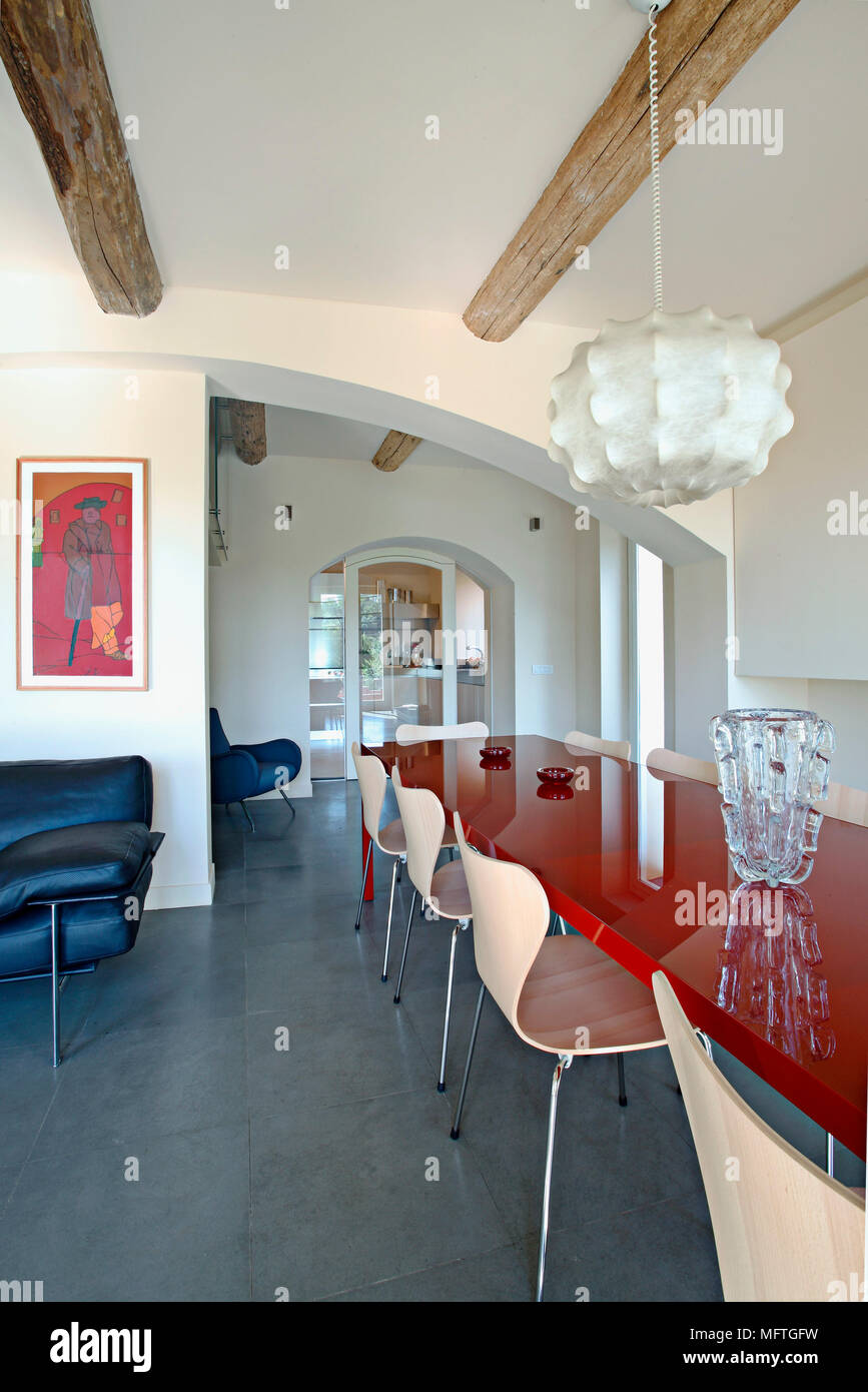 Chairs around wooden table in modern dining room Stock Photo - Alamy