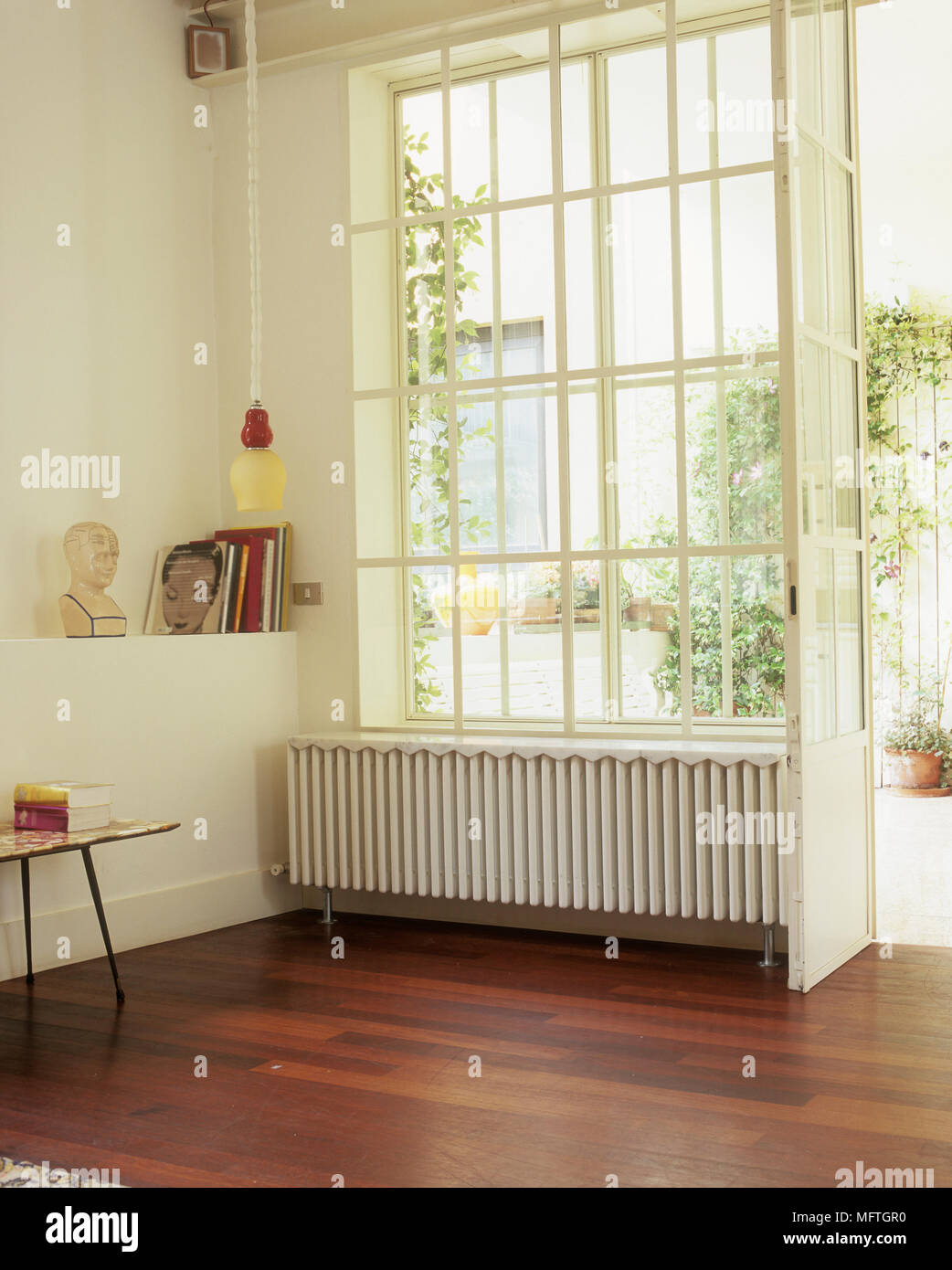 Radiator beneath window Stock Photo - Alamy