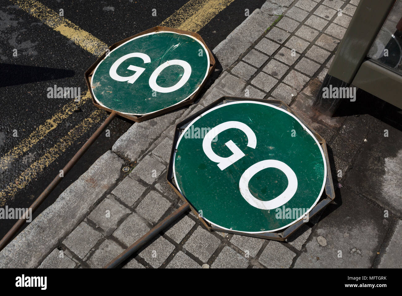 Two GO traffic road signs lie by the road in East Dulwich, on 26th ...