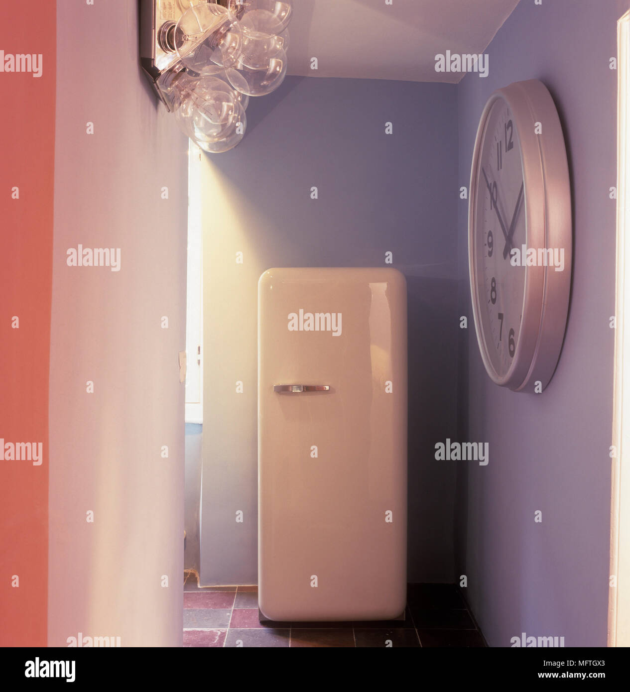 Oversize clock with fridge beyond Stock Photo - Alamy
